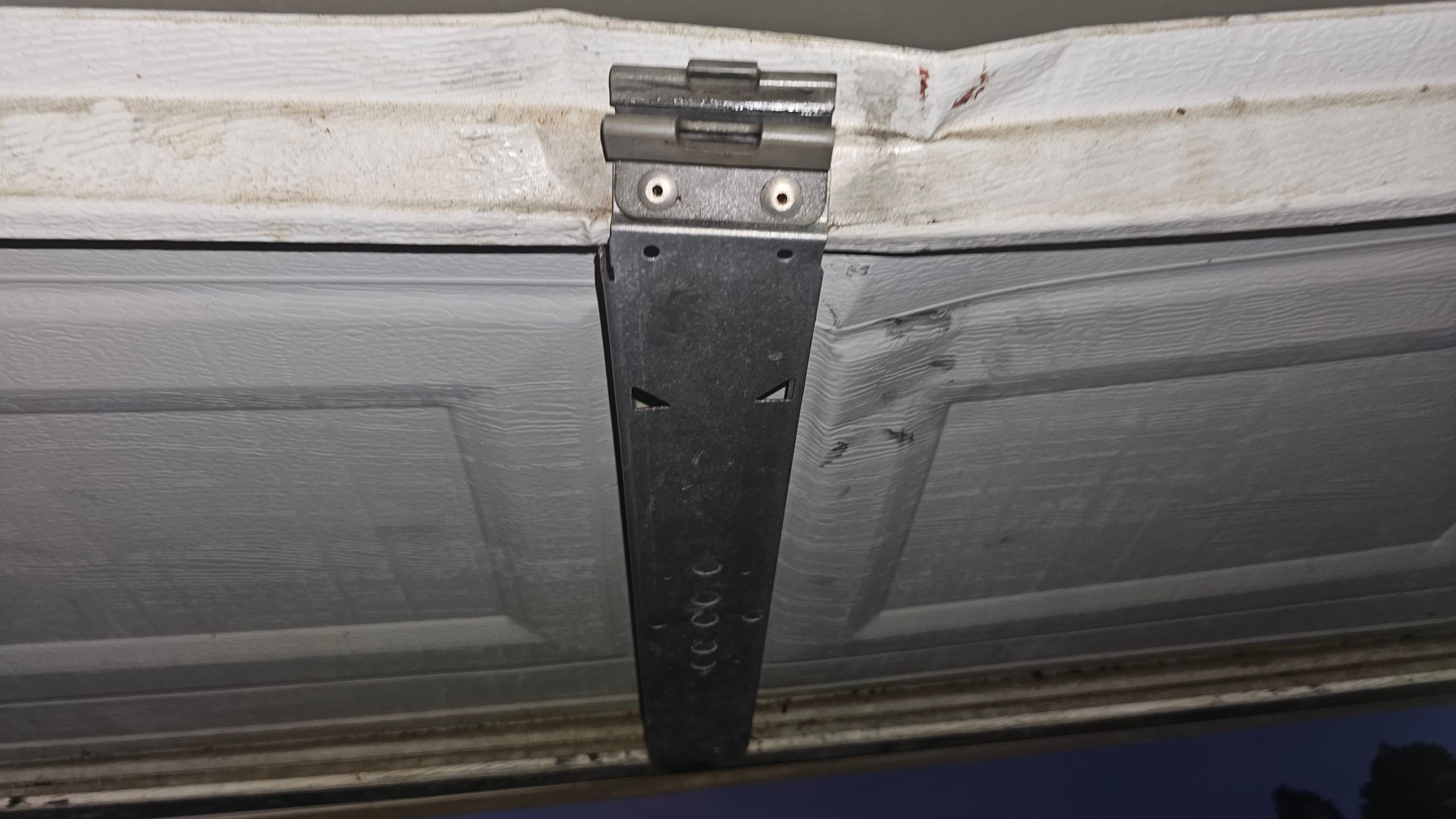 Older type plastic riveted hinge garage door folded on itself ...